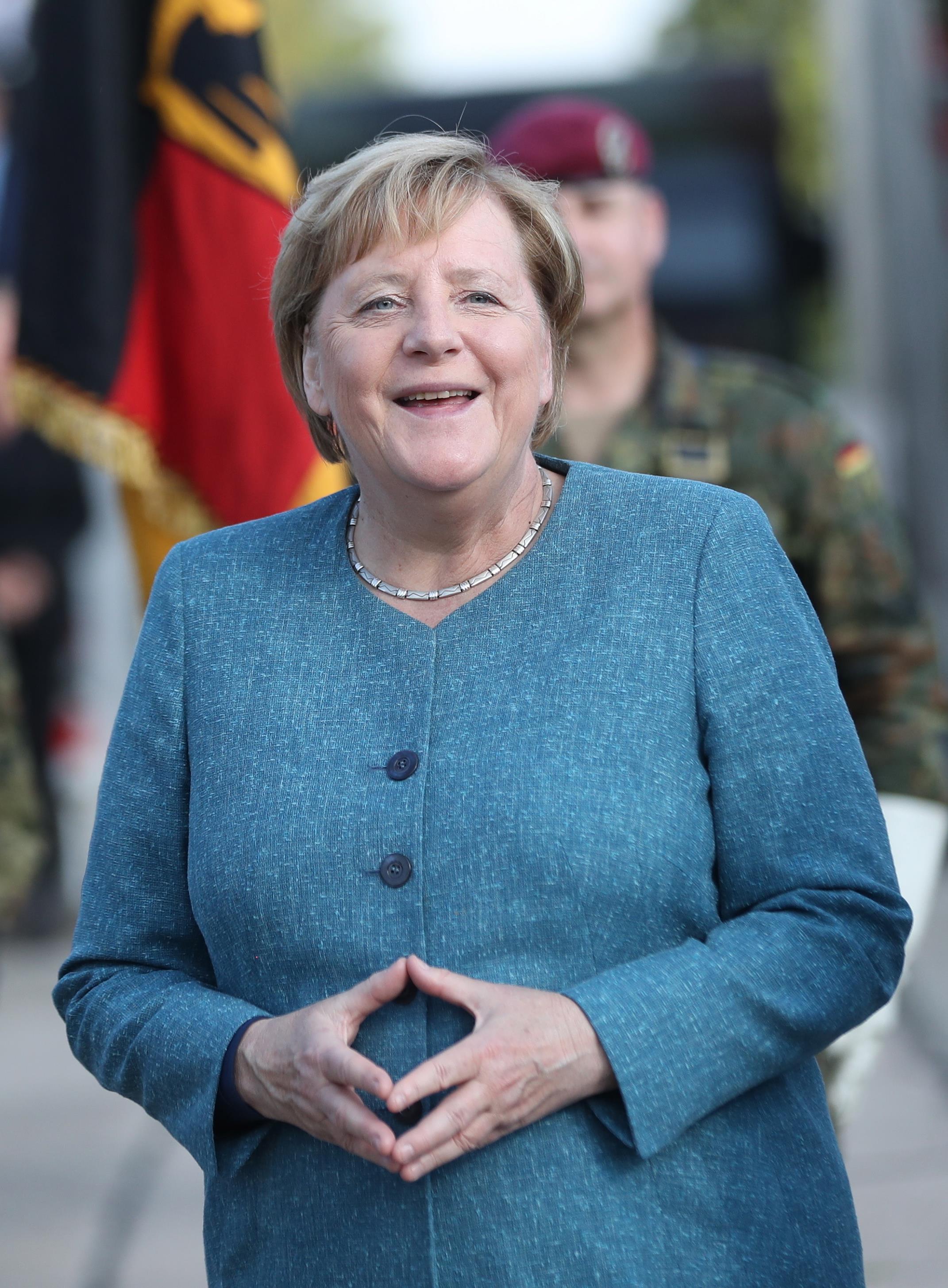 Angela Merkel displaying her famous 'rhombus' hard gesture. AAP